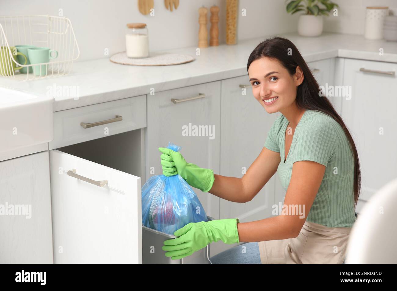 Woman taking full garbage hi-res stock photography and images - Alamy