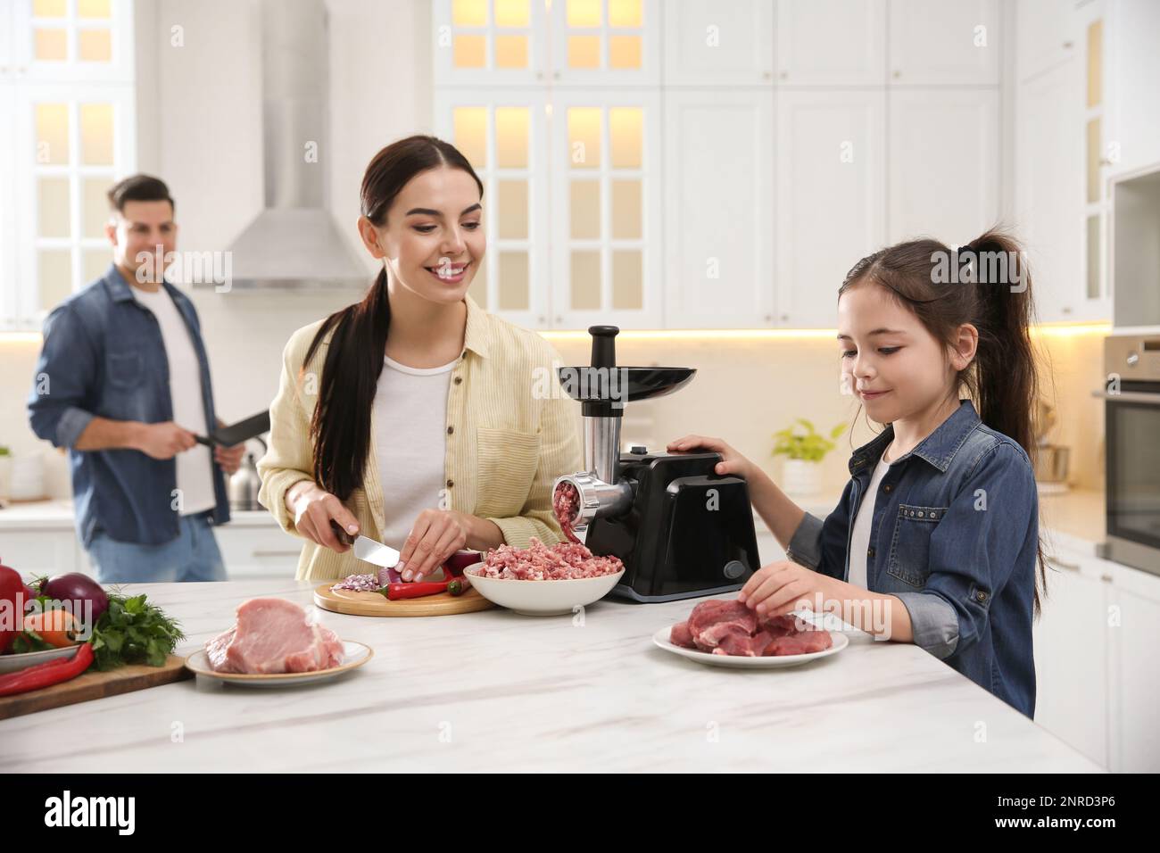 Happy family making dinner together in kitchen, little girl using ...