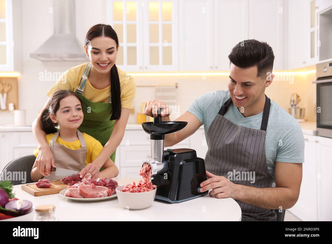 Happy family making dinner together in kitchen, father using modern ...
