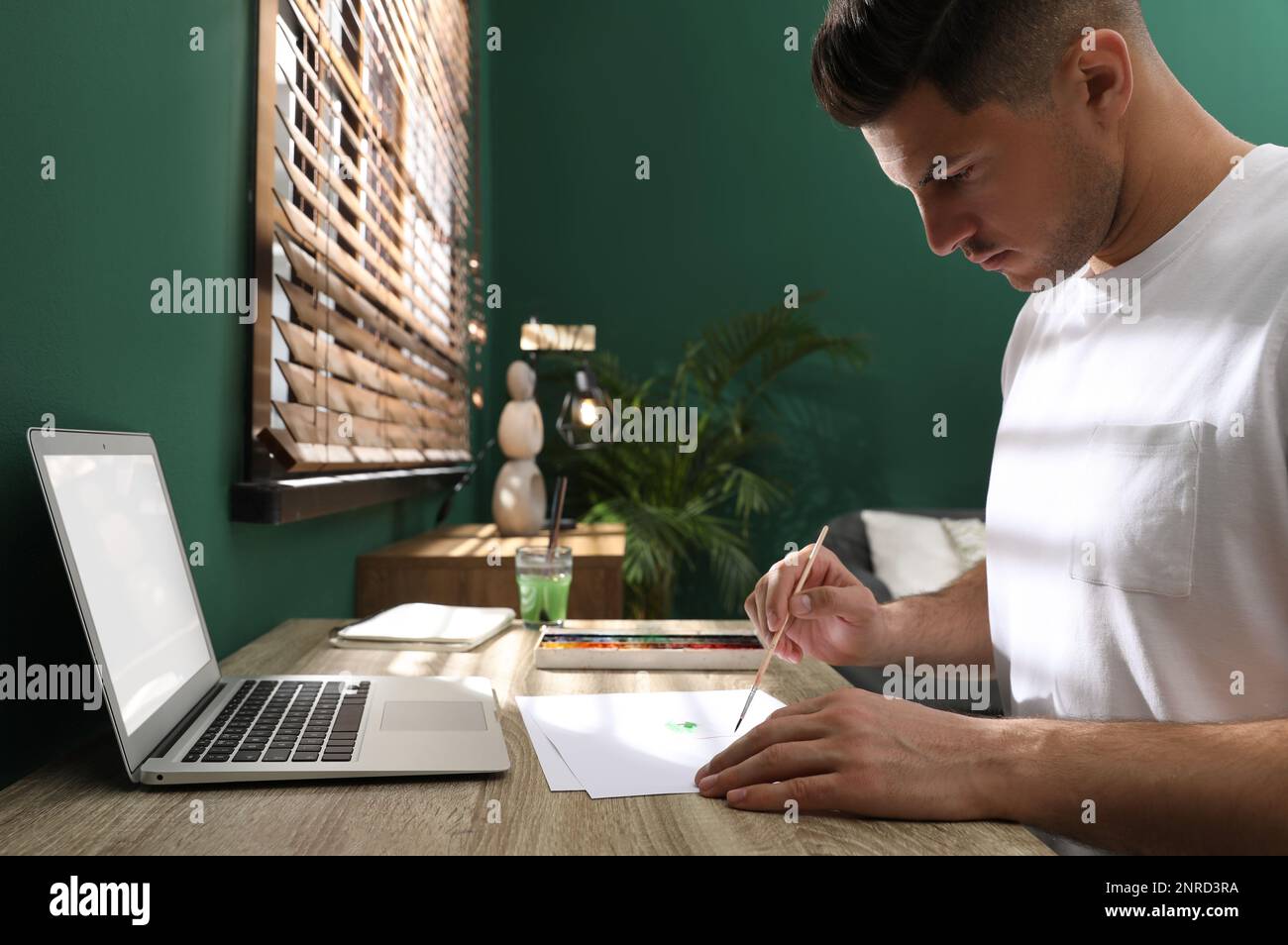 Man drawing with paints at online lesson indoors. Distance learning ...