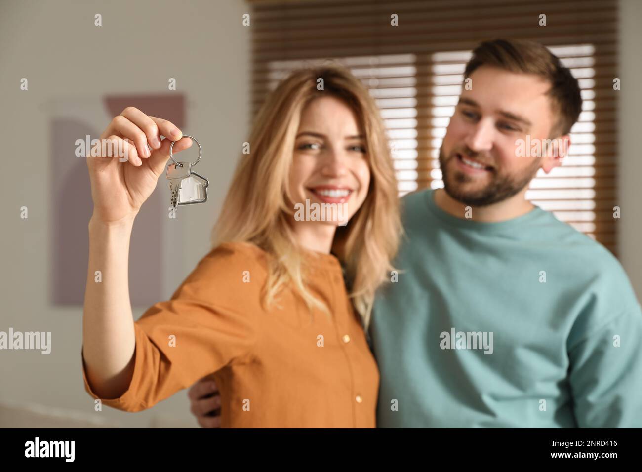 Happy young couple with key in new house, focus on hand Stock Photo - Alamy