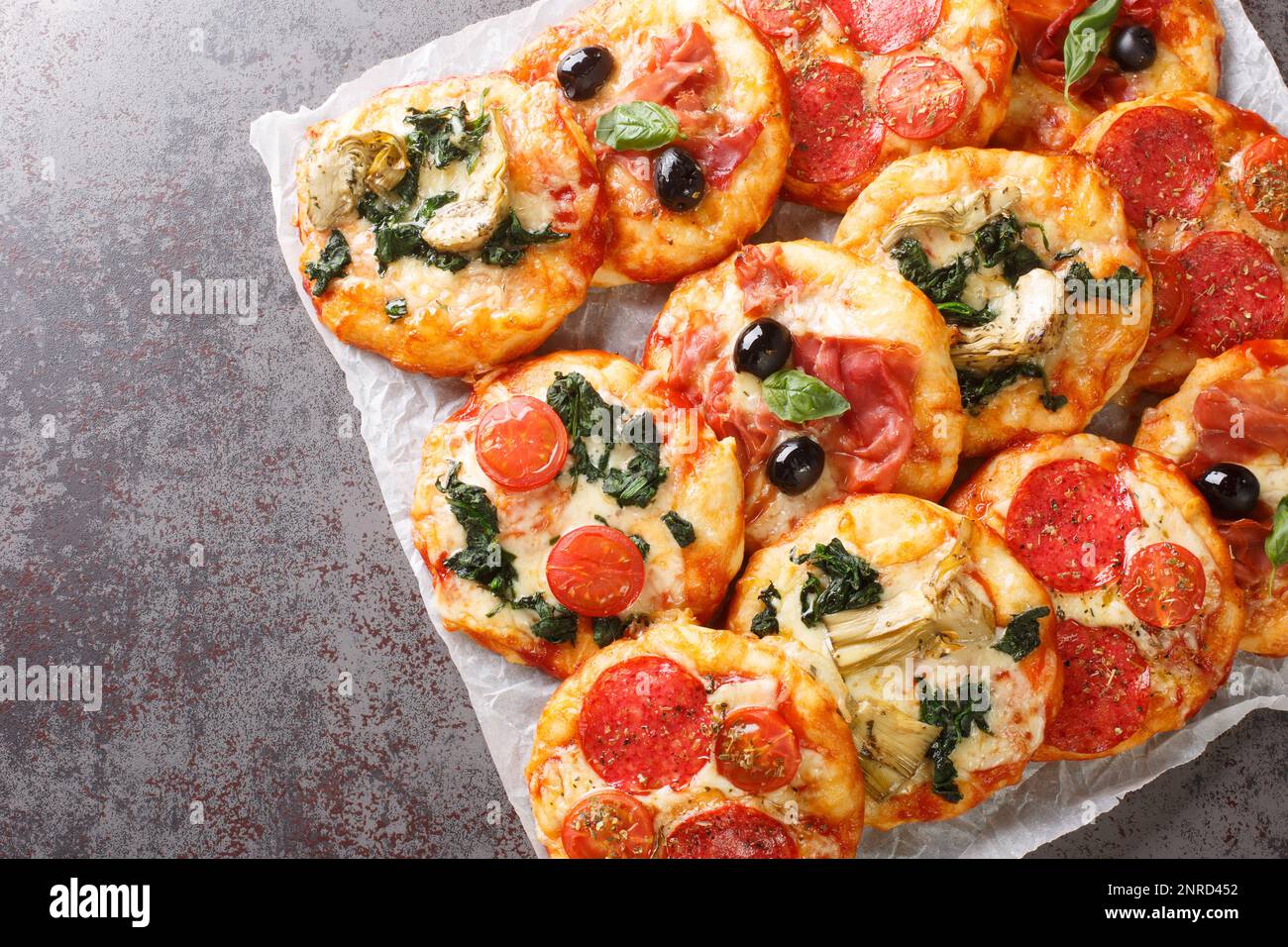 Italian Pizzette Mini Pizza Bites With Assorted Toppings close-up on ...