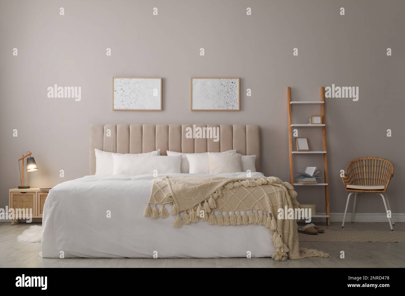Cozy bed with soft linens in light room Stock Photo - Alamy