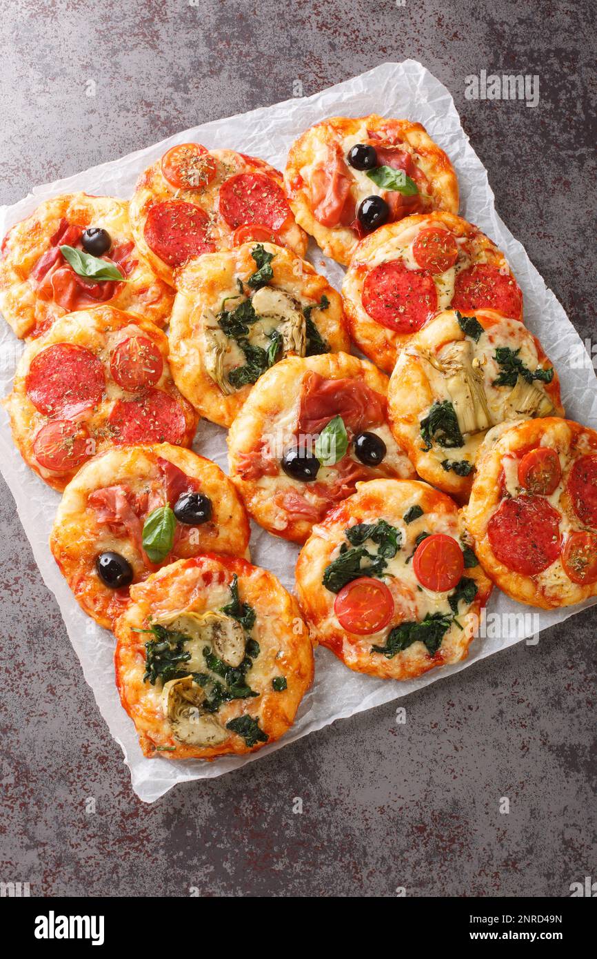 Homemade Mini Pizzas Pizzette with meaty and vegetarian toppings close ...
