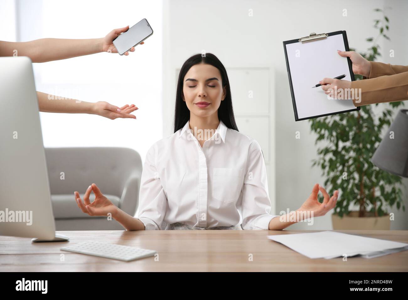 Overwhelmed woman meditating at workplace. Stress relief exercise Stock ...