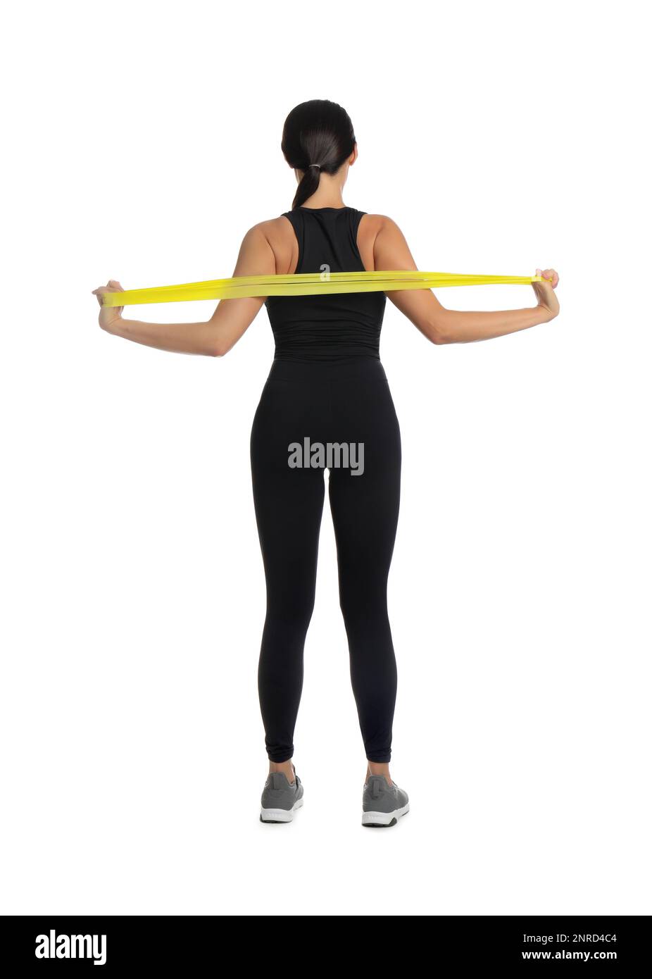 Woman doing sportive exercise with fitness elastic band on white ...