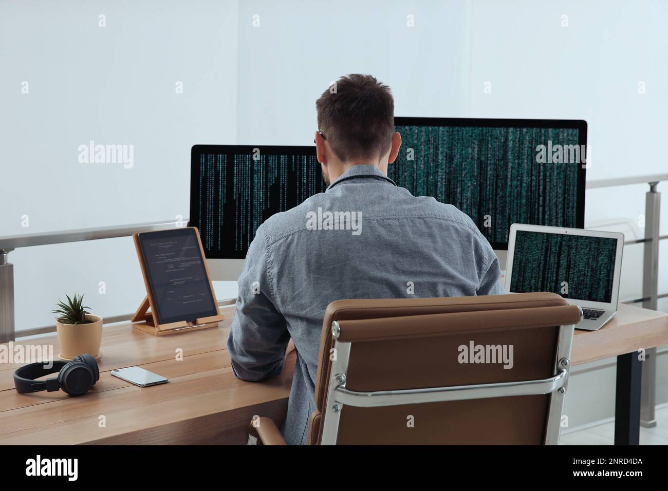 Programmer working at desk in modern office Stock Photo - Alamy