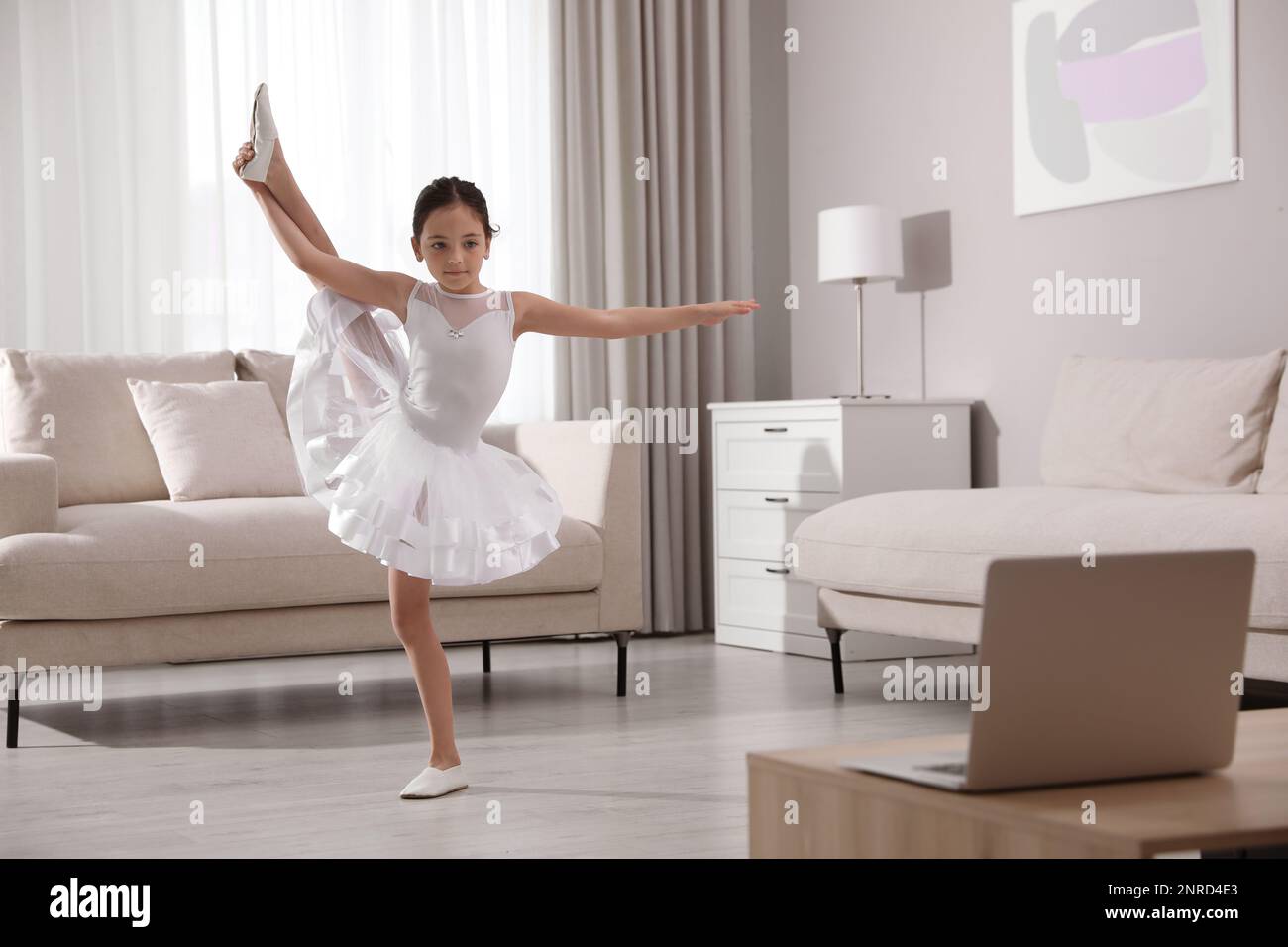 Cute little girl taking online dance class at home Stock Photo - Alamy
