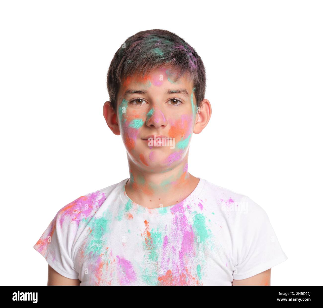 Teenage boy covered with colorful powder dyes on white background. Holi ...