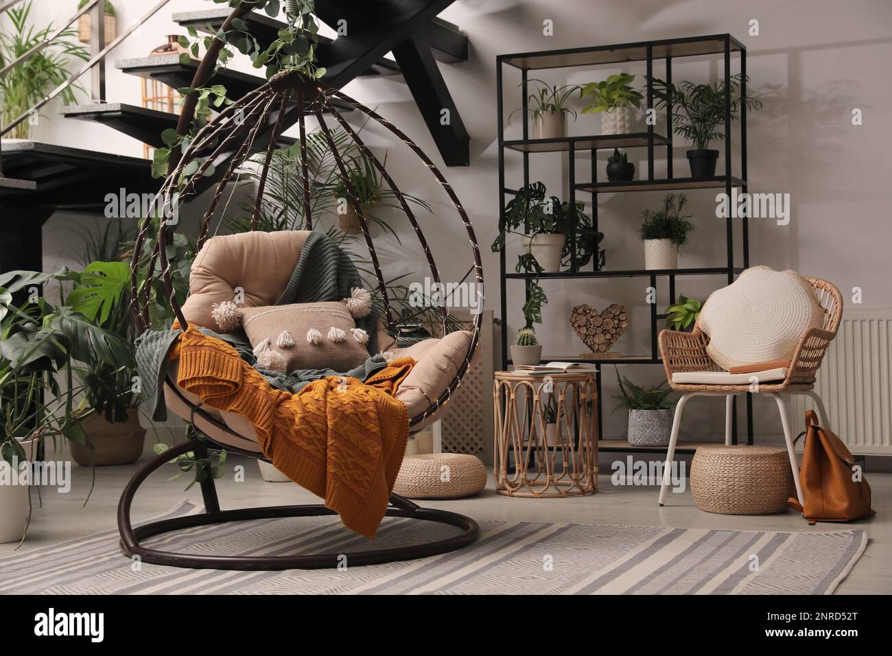 Indoor terrace interior with hanging chair and green plants Stock Photo ...