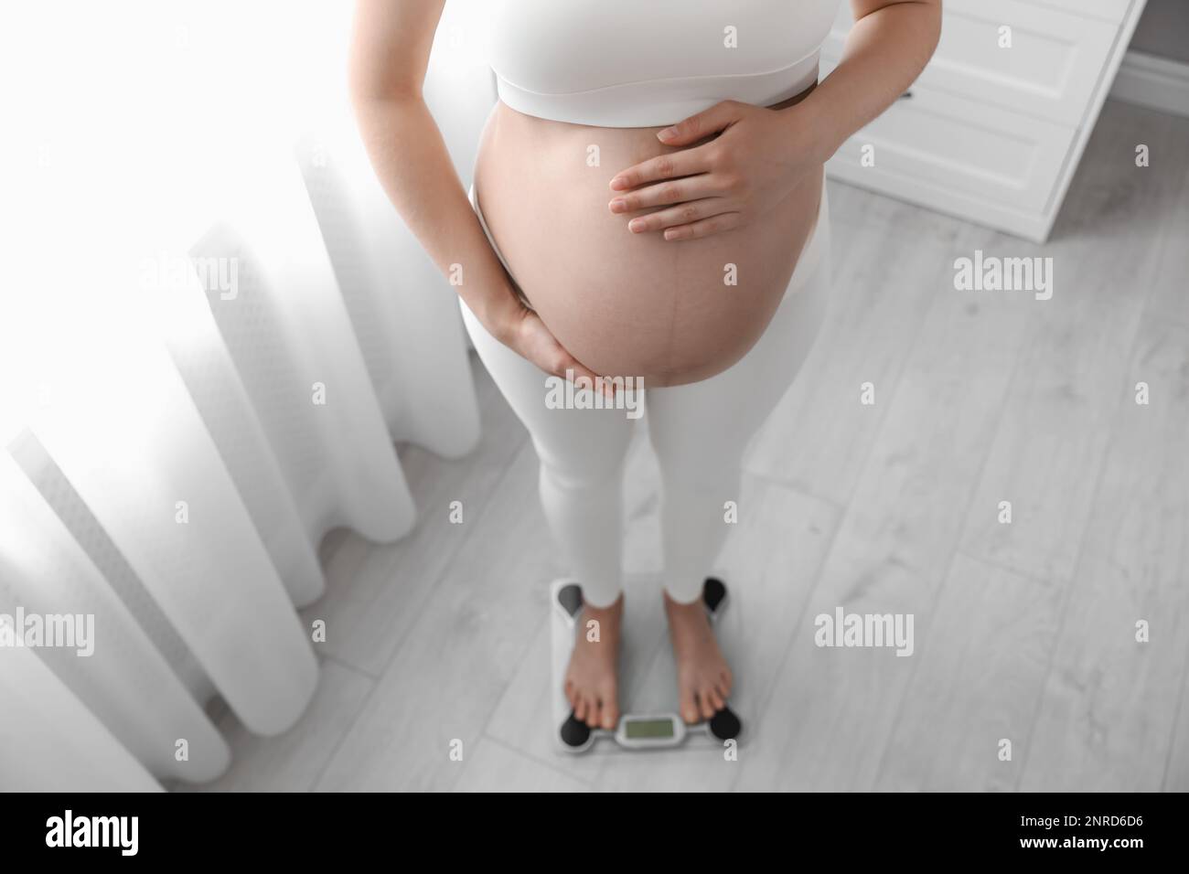 Woman standing on scales hi-res stock photography and images - Alamy