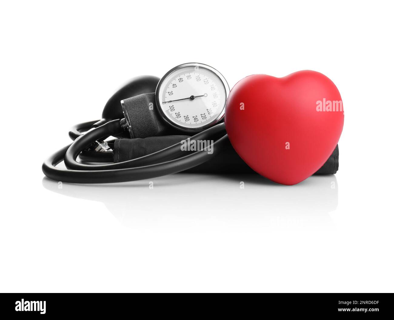 Blood pressure meter and toy heart on white background Stock Photo - Alamy