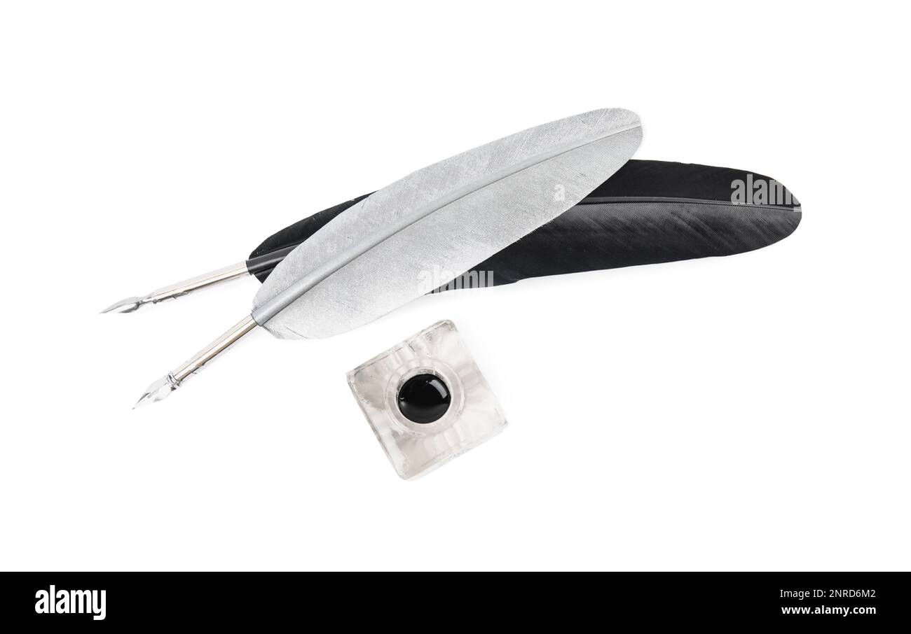 Feather pens and inkwell on white background, top view Stock Photo - Alamy