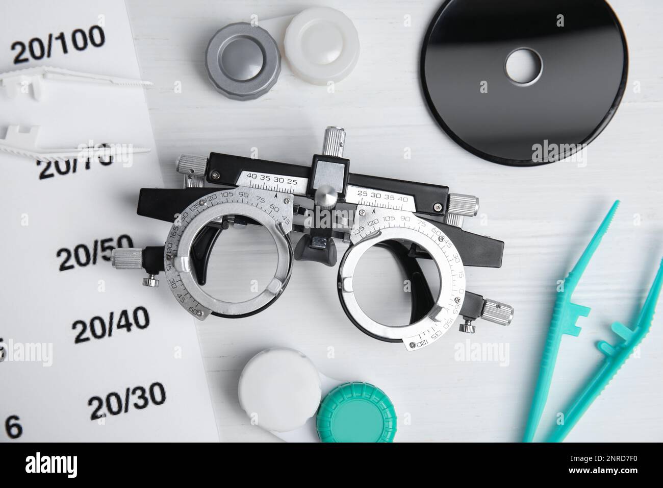 Different ophthalmologist tools on white wooden background, flat lay ...