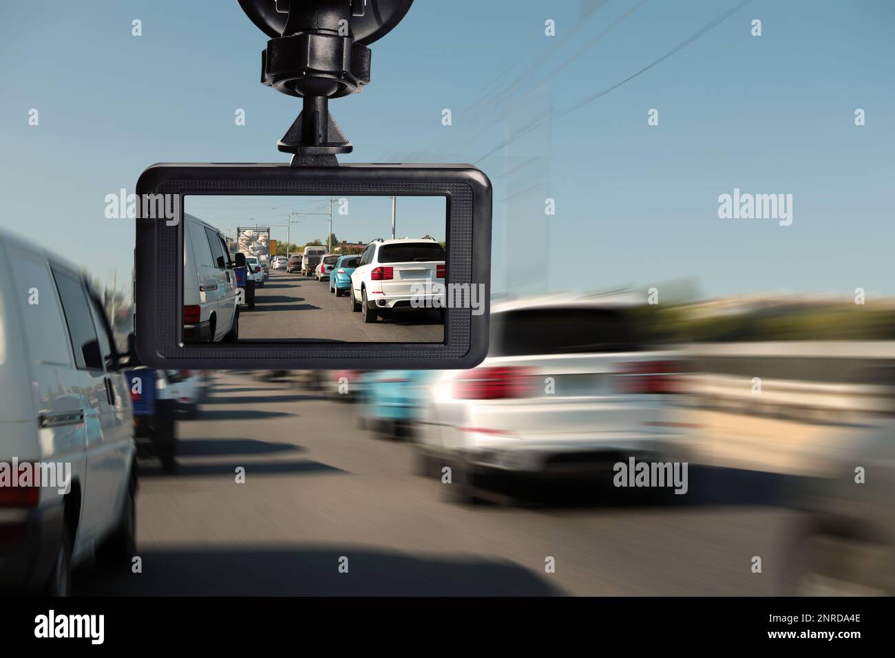 Modern dashboard camera mounted in car, view of road during driving ...