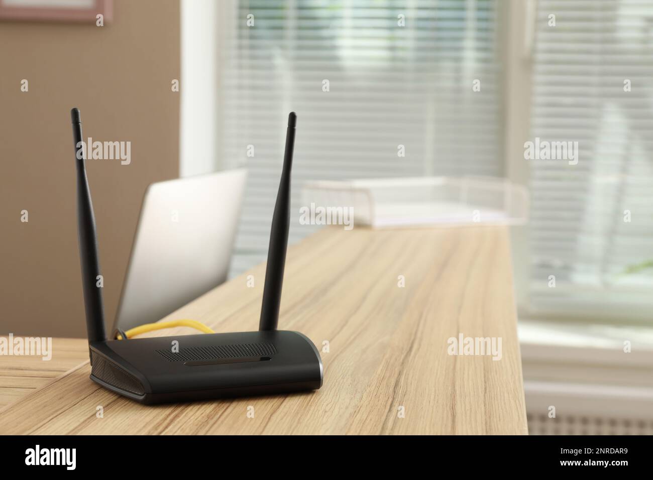 Modern wi-fi router on wooden counter indoors Stock Photo - Alamy