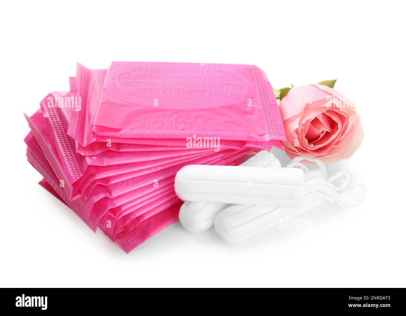 Tampons, disposable menstrual pads and beautiful rose on white ...