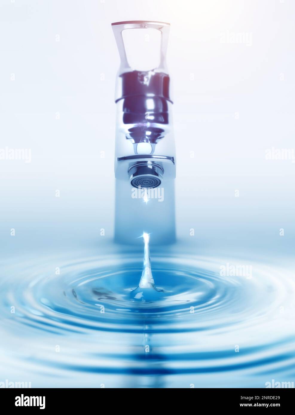 Water dripping from tap with splash on light background Stock Photo - Alamy