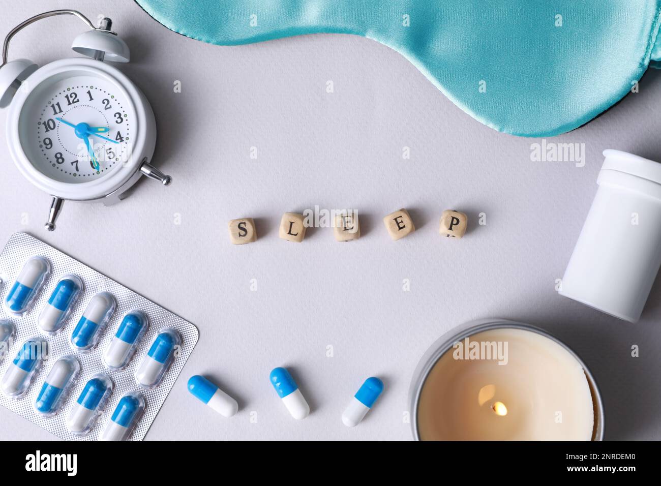 Flat lay composition with word Sleep made of cubes on white background ...