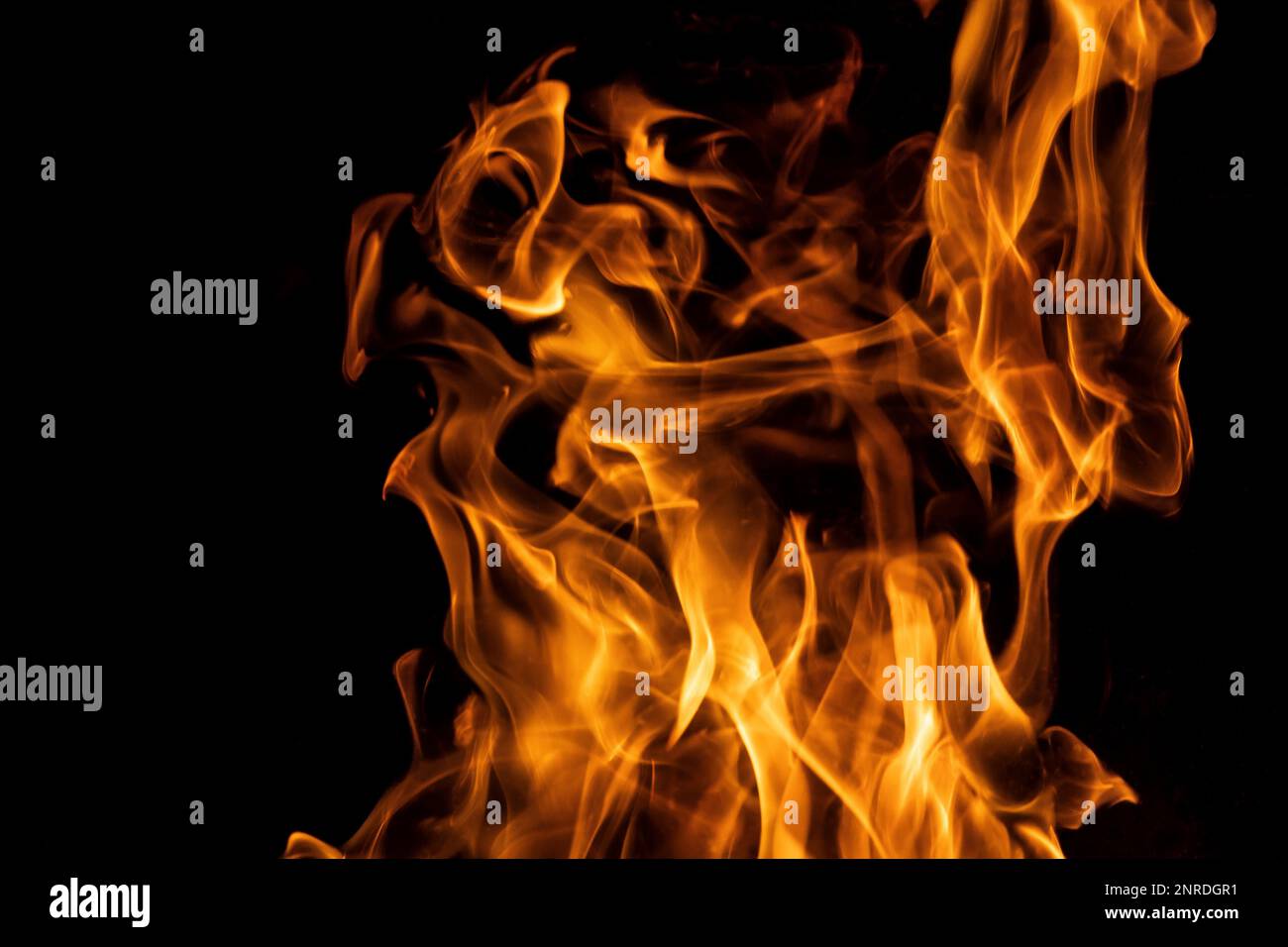 A bright fire against a black background Stock Photo - Alamy