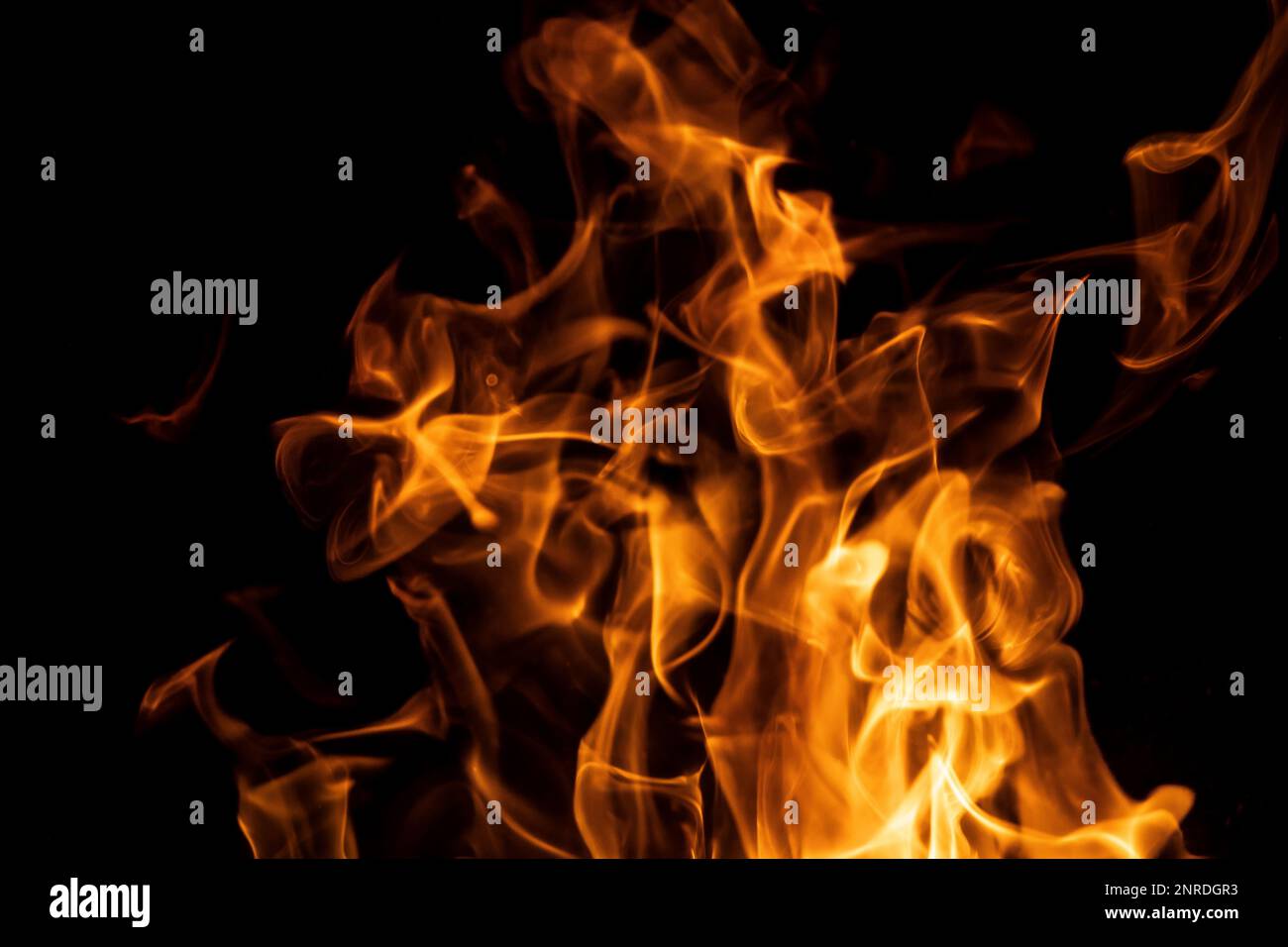 A blazing fire against a black background Stock Photo - Alamy