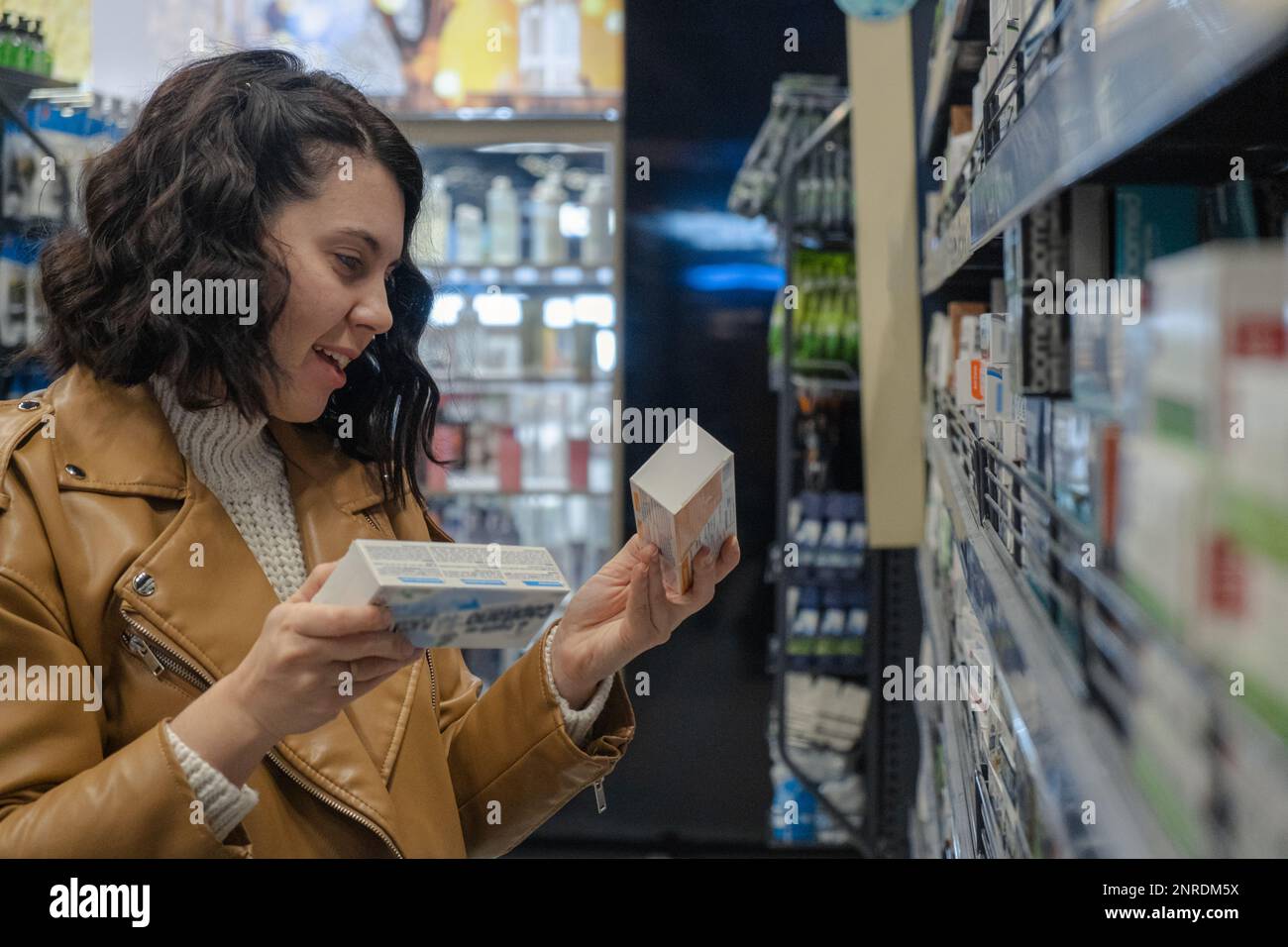 a woman chooses toothpaste in a store Stock Photo - Alamy