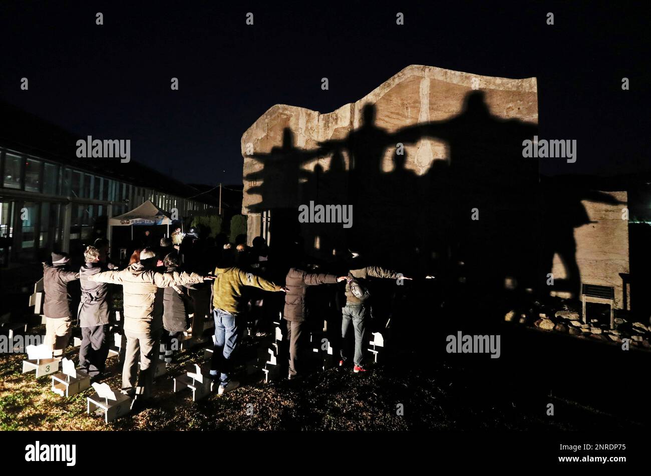 "Kobe Wall" lit up to show the cross by participants' shadows prior to ...