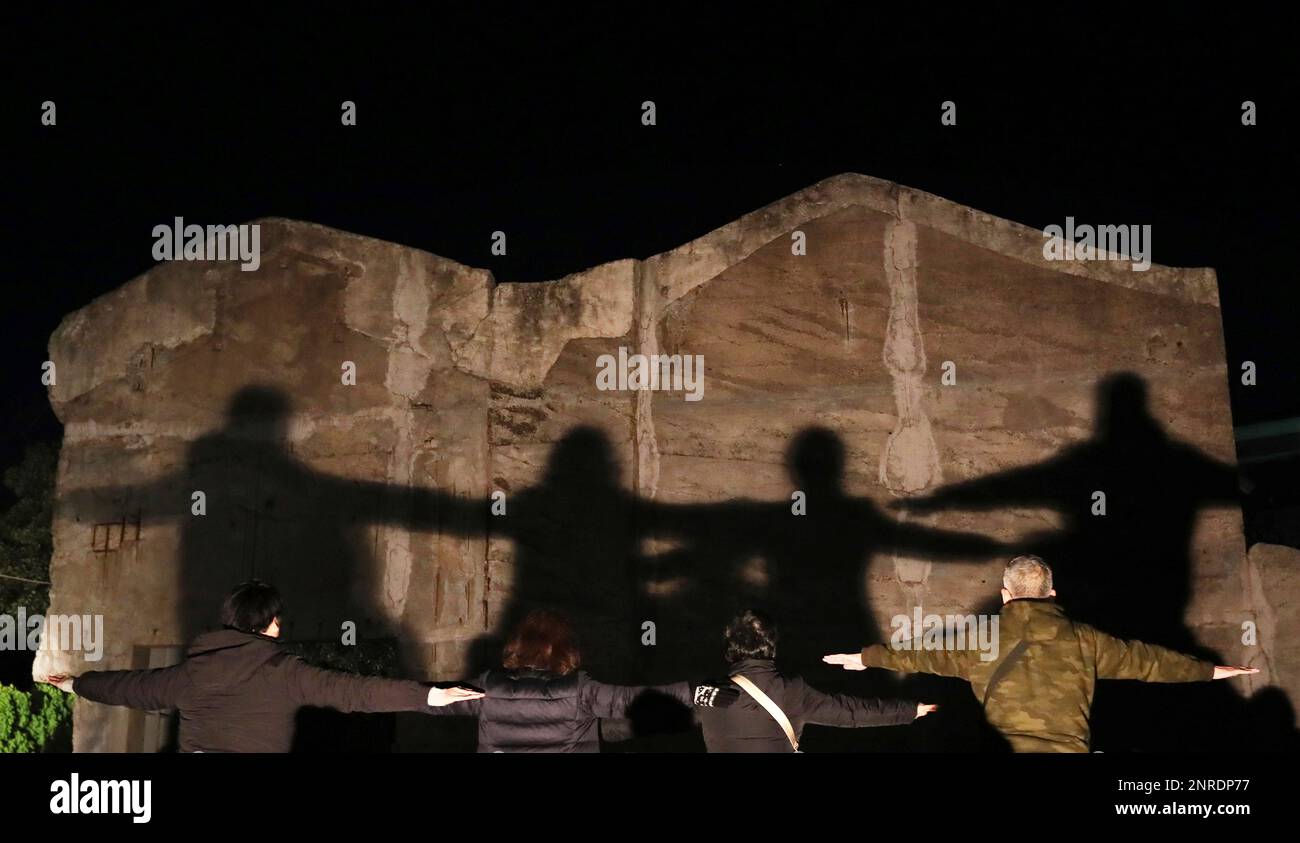 "Kobe Wall" lit up to show the cross by participants' shadows prior to ...