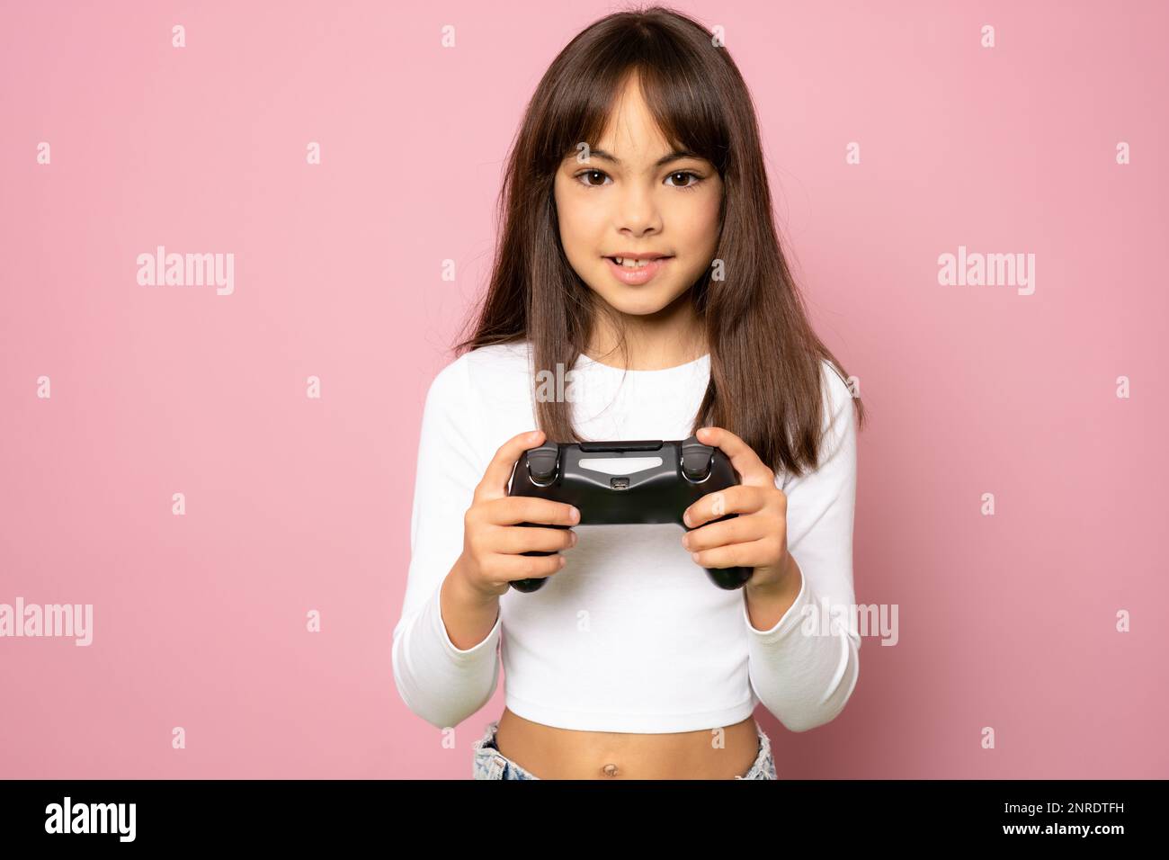Portrait of little girl wearing striped T-shirt holding in hands red ...