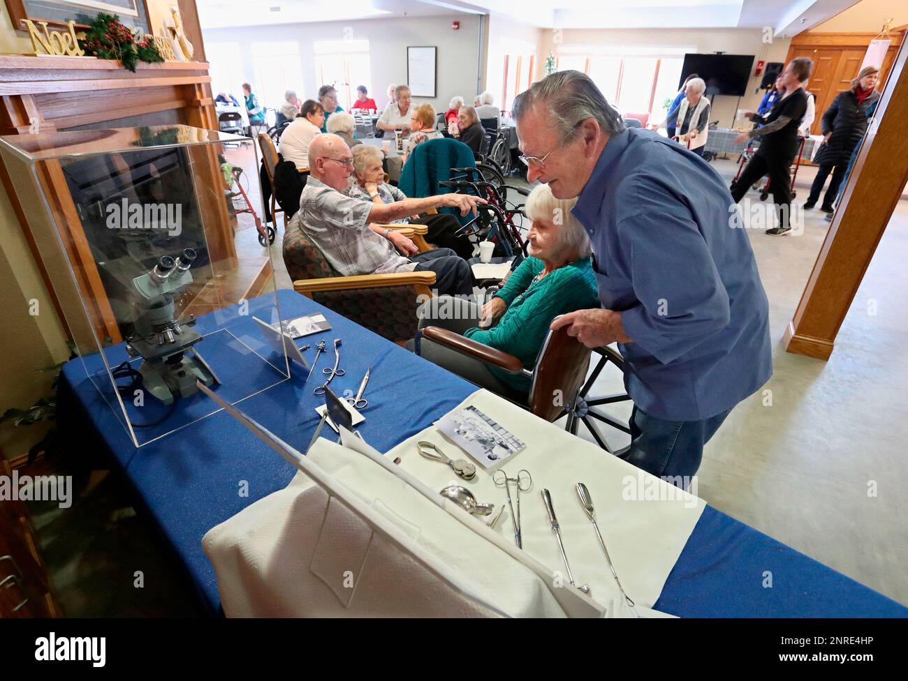 Roger Ackerman, right, and Marcia Carls, center, look over some of the ...