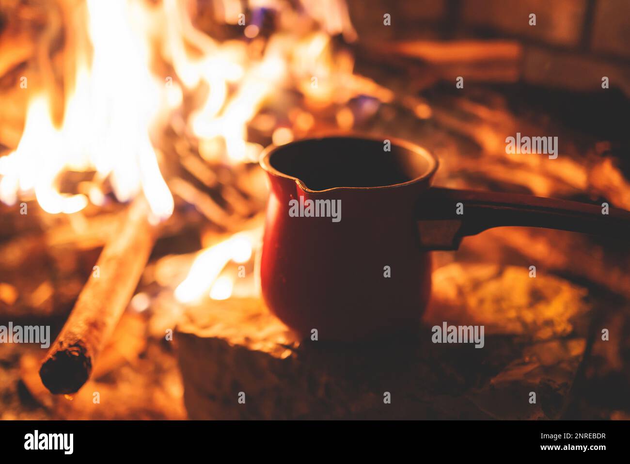 Warming up the fire, cozy winter night in the scandinavian cottage ...
