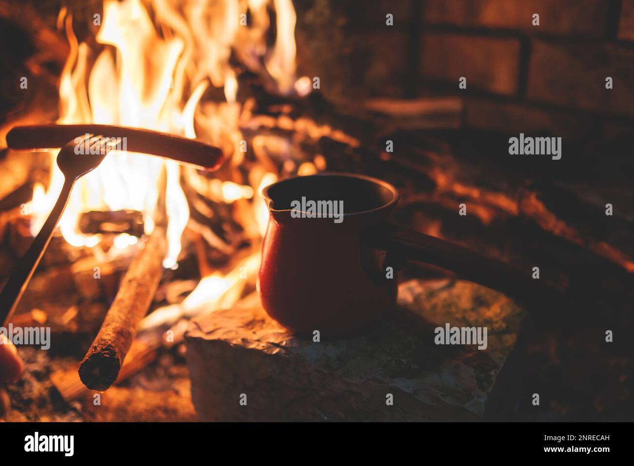 Warming up the fire, cozy winter night in the scandinavian cottage ...
