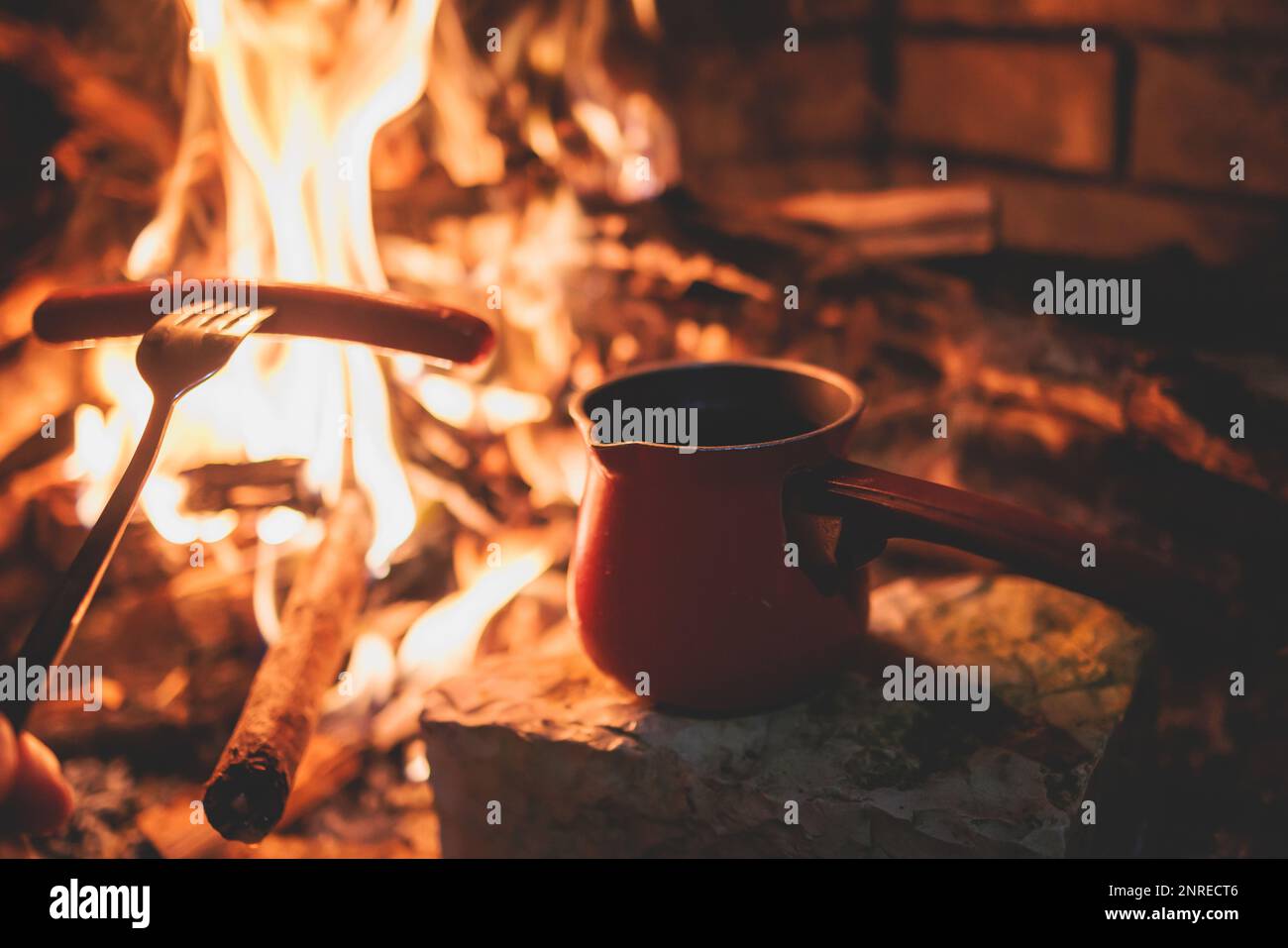 Warming up the fire, cozy winter night in the scandinavian cottage ...