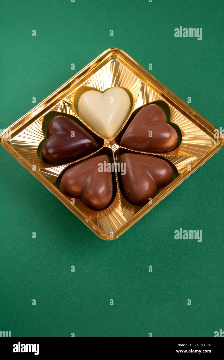 photo chocolates of different chocolates lying in a package on a green ...