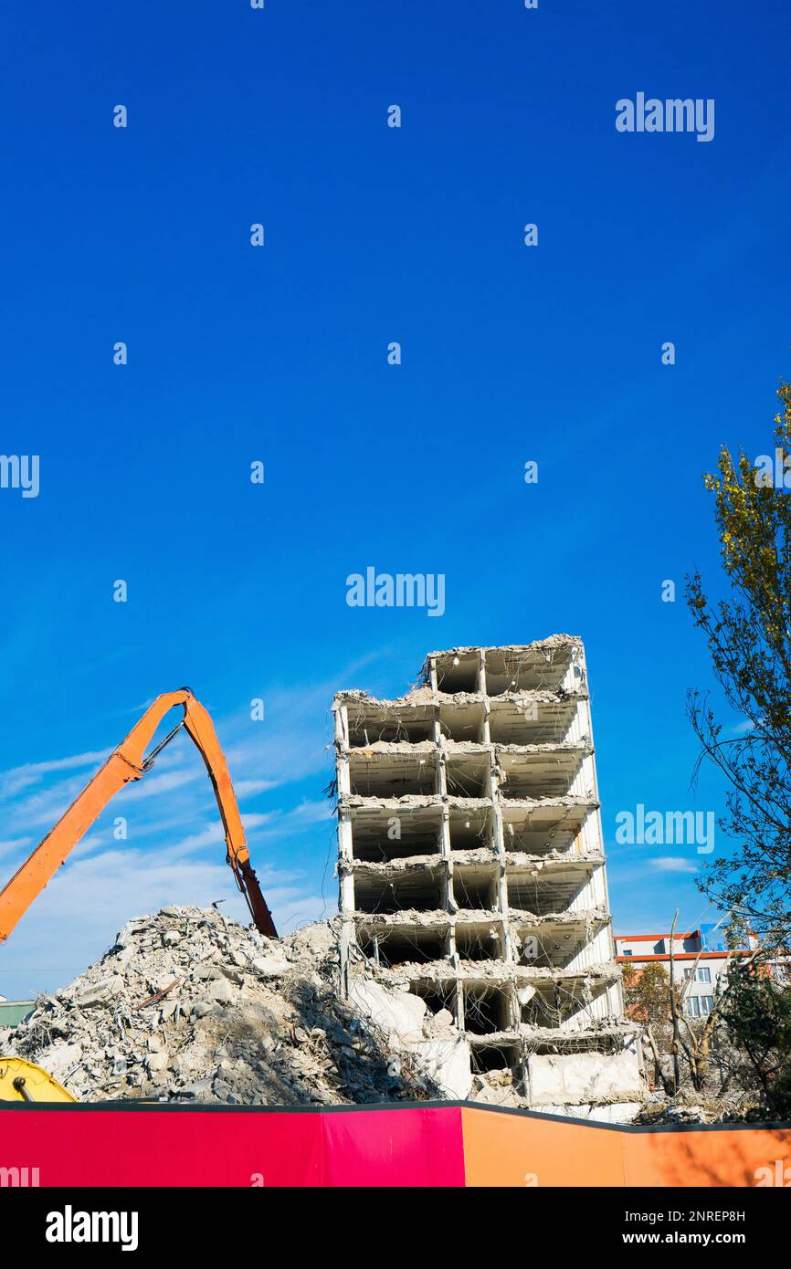 Background of process of demolition of building. Excavator breaking old ...