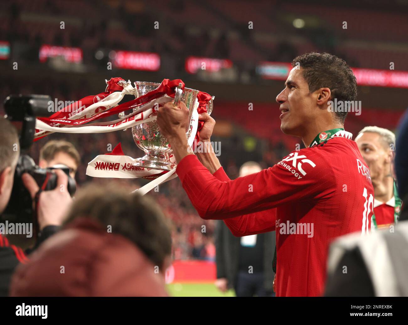 Wembley, UK. 26th Feb, 2023. Raphael Varane (MU) with the cup at the ...