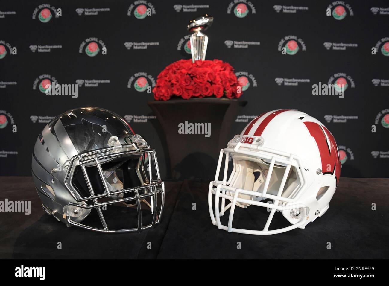 Oregon Ducks and Wisconsin Badgers helmets and Leishman Trophy on ...