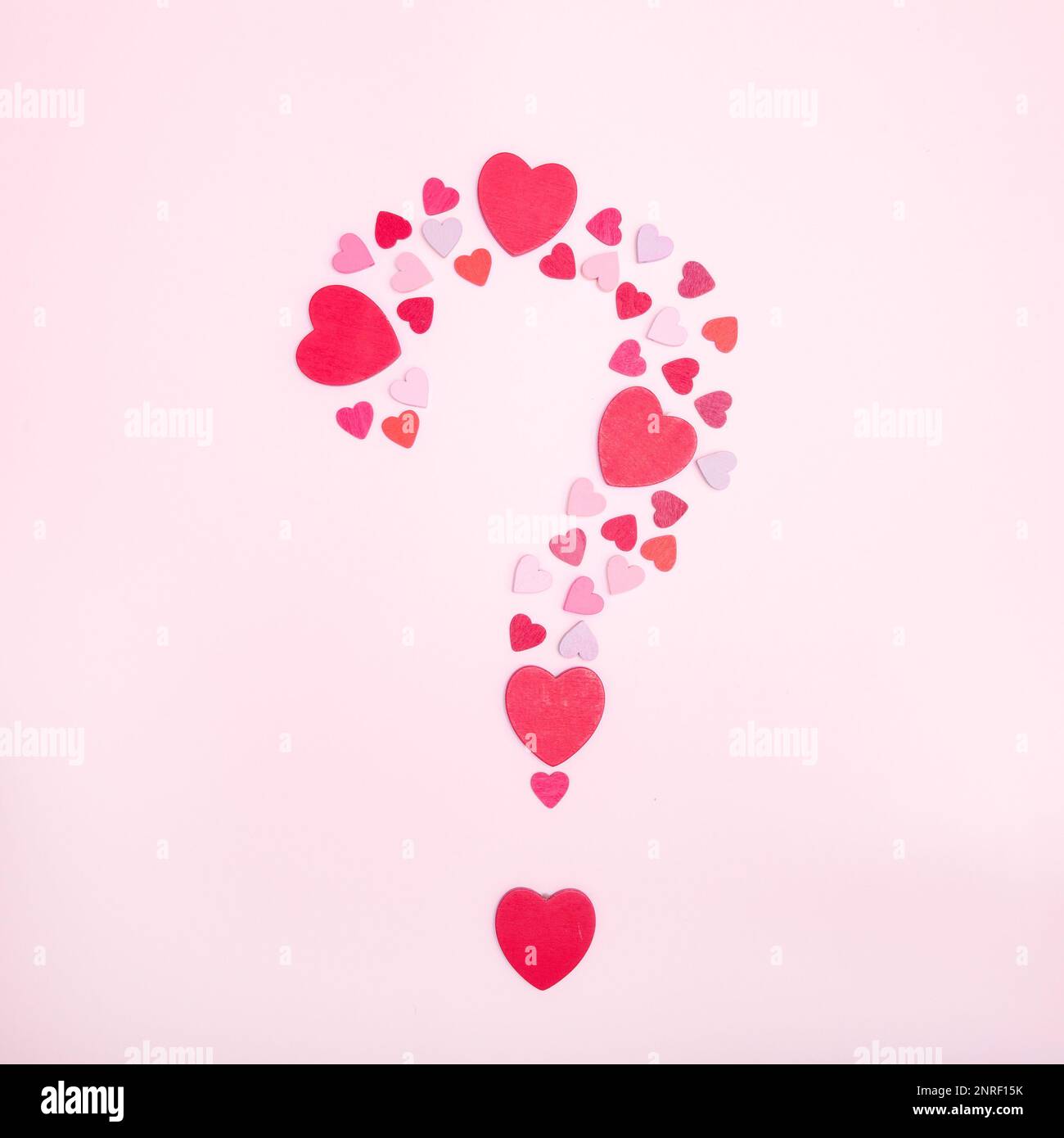 Question symbol made from hearts on a pink background. Marriage ...