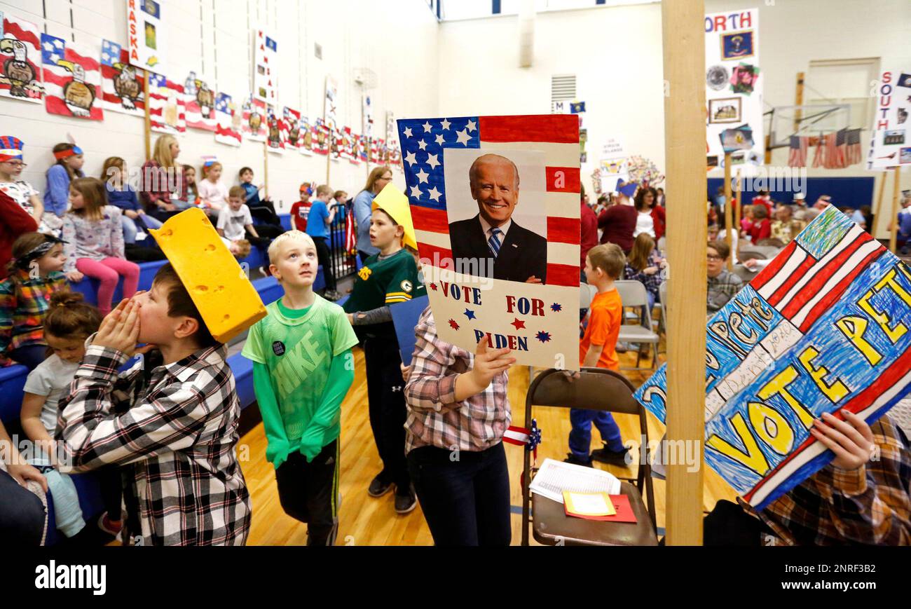 Students march around their gym cheering and holding signs for certain ...