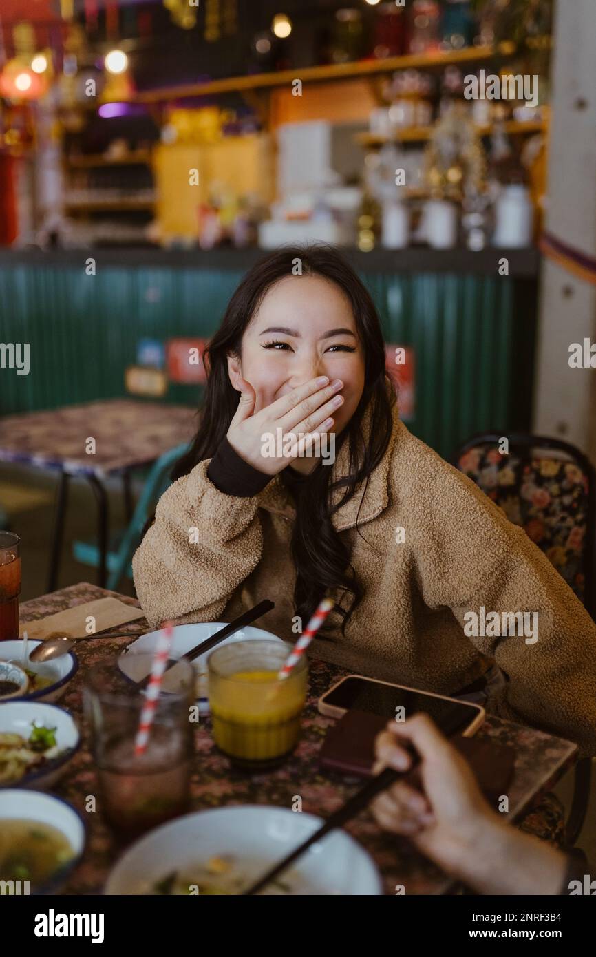 Asian woman covering mouth laughing hi-res stock photography and images ...