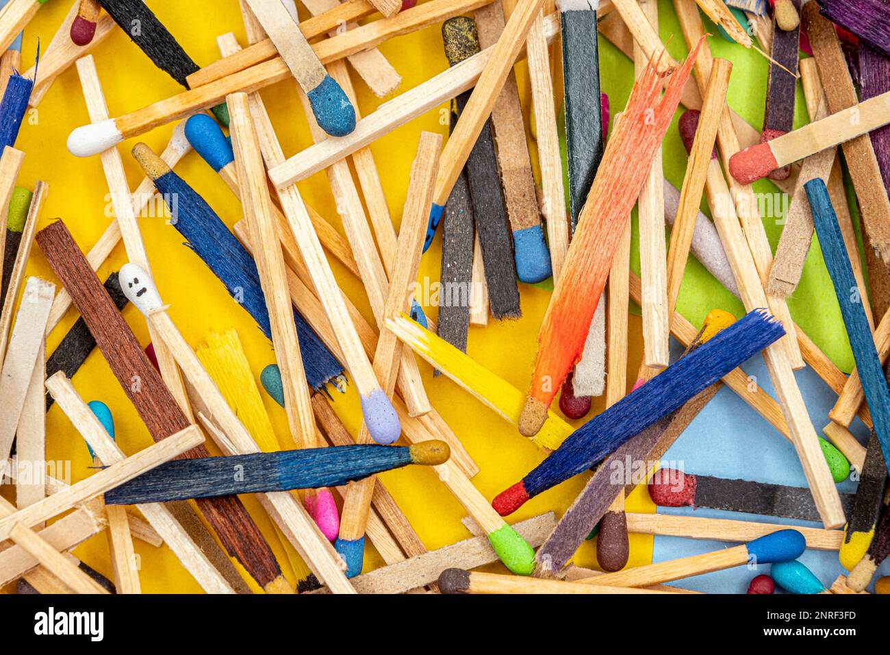 matchsticks of various shapes and colors with multicolored paper sticky ...