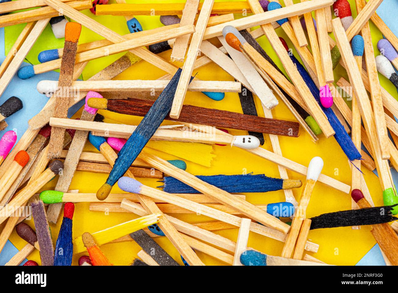 matchsticks of various shapes and colors with multicolored paper sticky ...