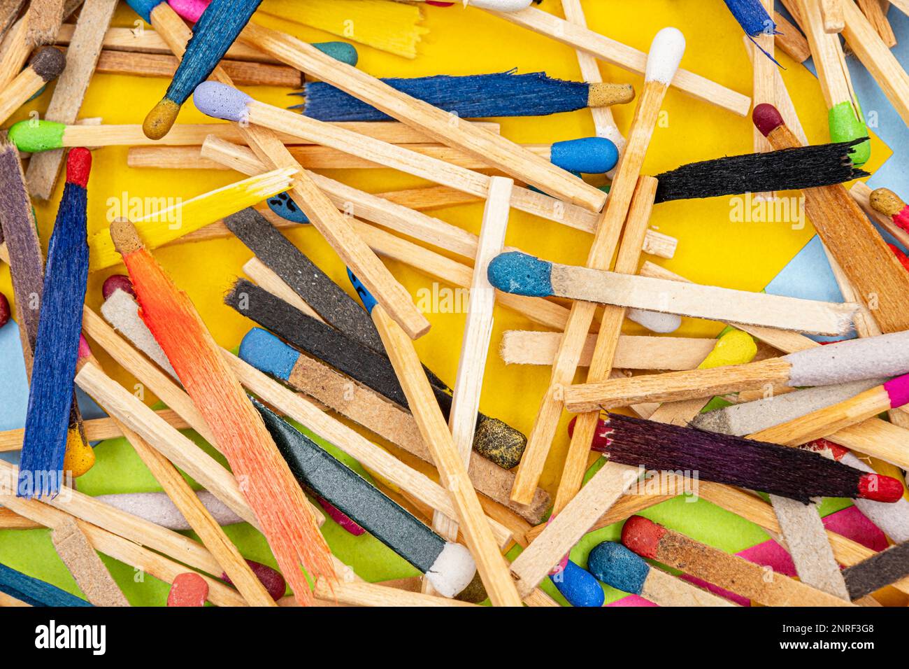 matchsticks of various shapes and colors with multicolored paper sticky ...