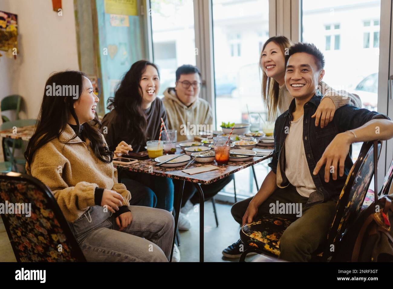 Smiling friends together lunch hi-res stock photography and images - Alamy