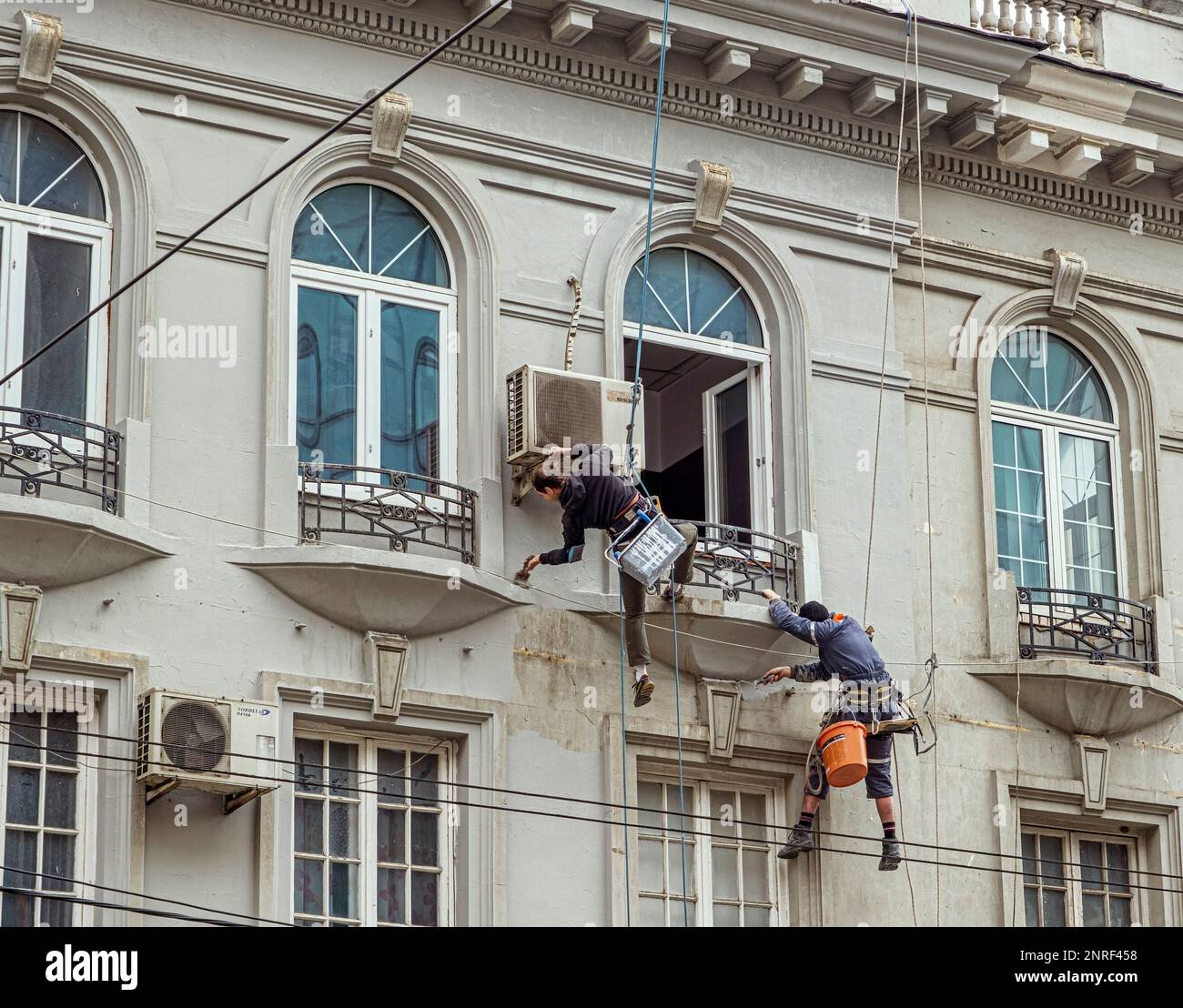 Bucharest city, Romania - 21 February, 2023. Industrial alpinist at ...