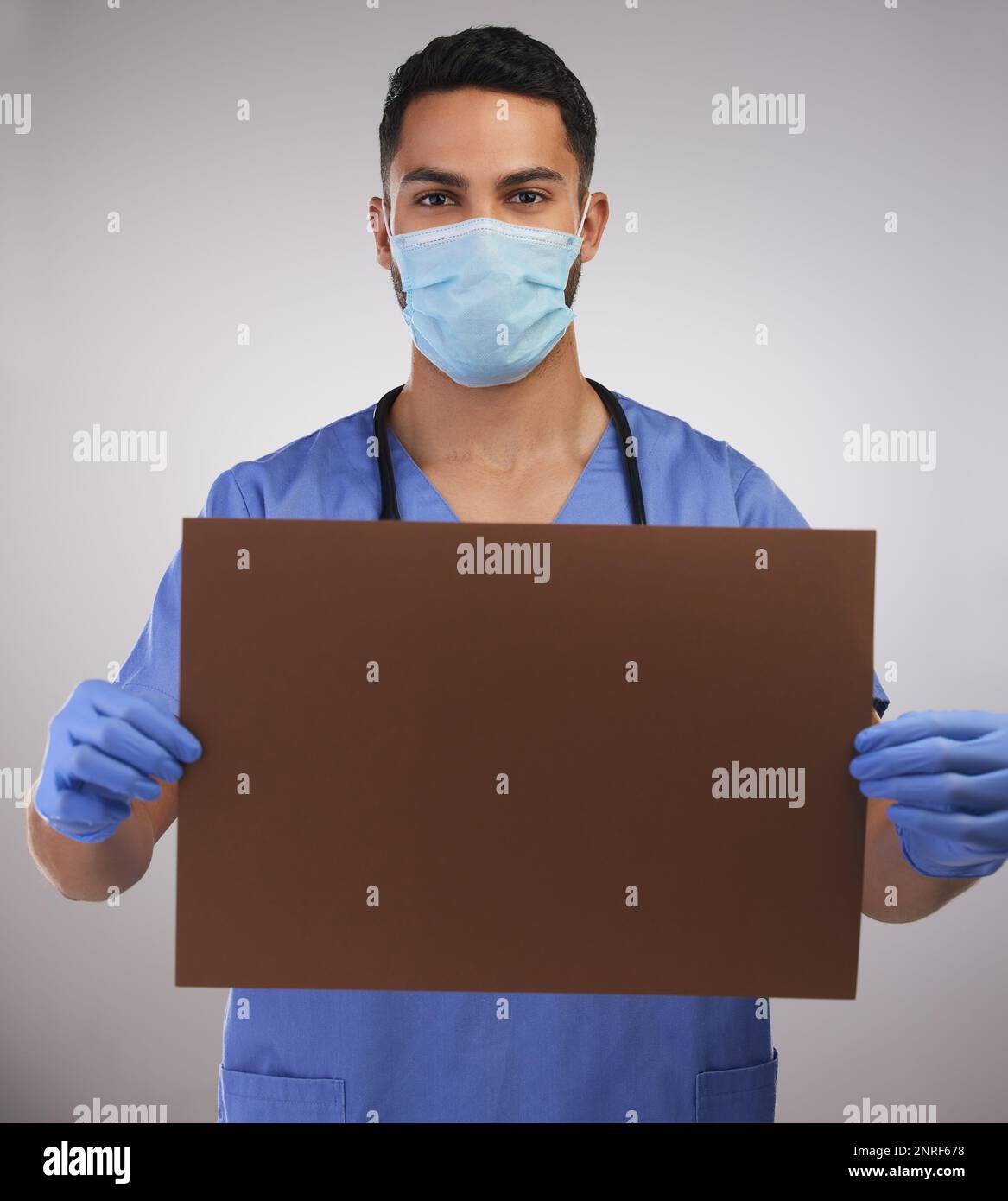 Your health comes first. a handsome young nurse standing in the studio ...