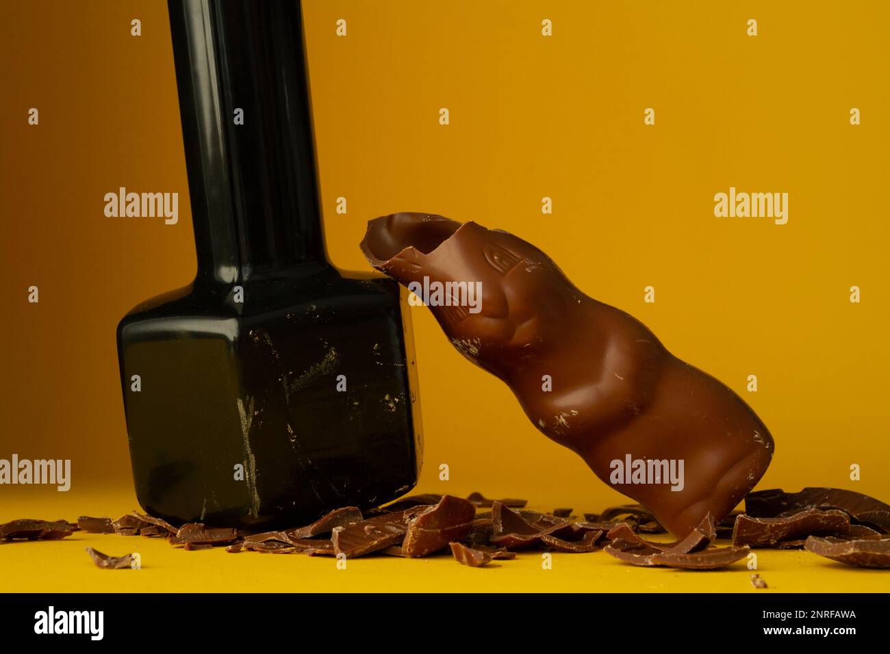 Dumbbell crushing Easter chocolate bunny. Gym workout, fitness exercise ...