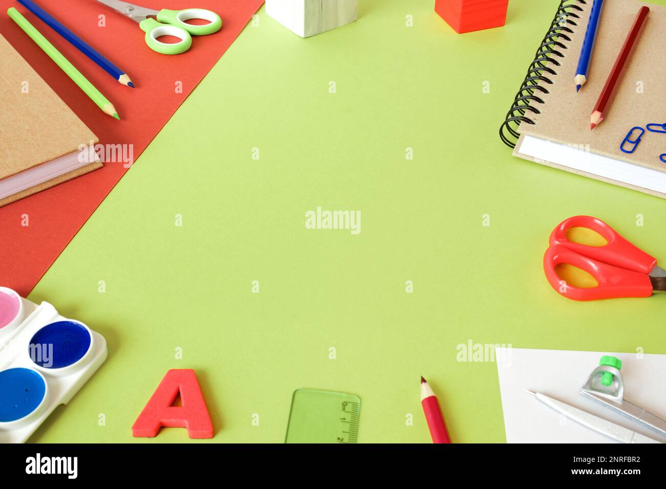 Colorful school supplies on light green background. Many Office ...