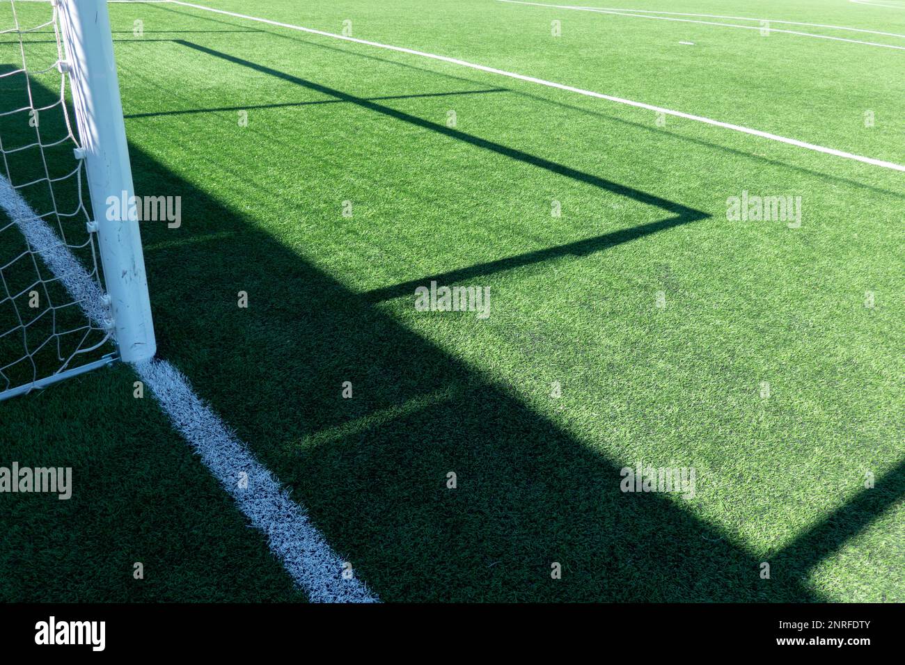 Artificial turf on football soccer field. Part of soccer goal and green ...