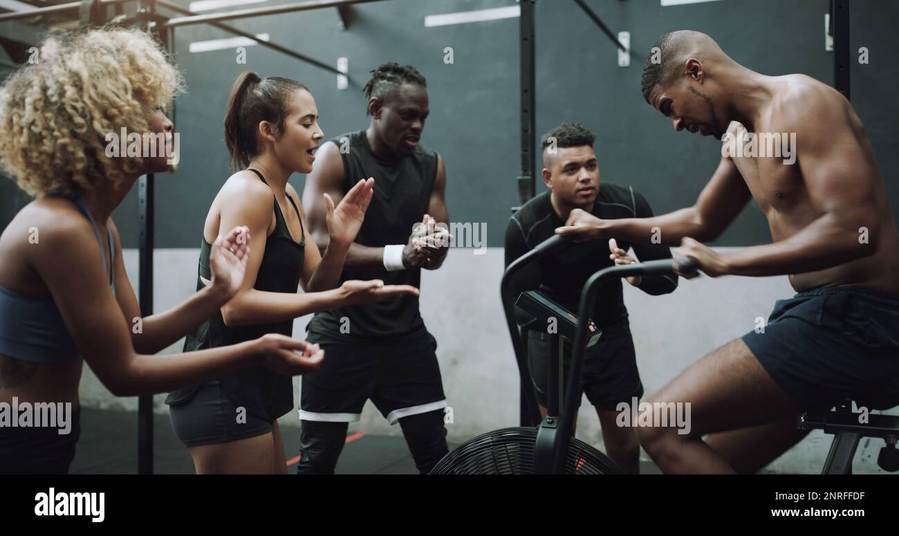 All the encouragement helps him get further. a young man working out on ...